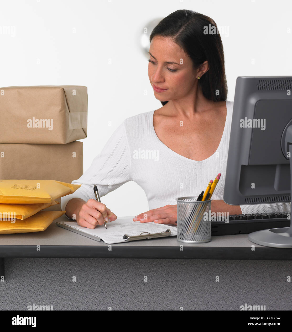 Woman logging in packages at counter Stock Photo - Alamy