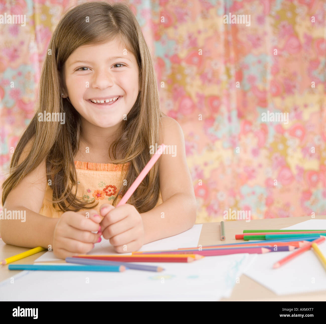 Young girl smiling and coloring Stock Photo - Alamy