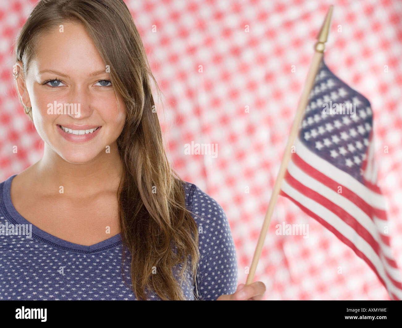 Young woman smiling and holding American flag Stock Photo - Alamy