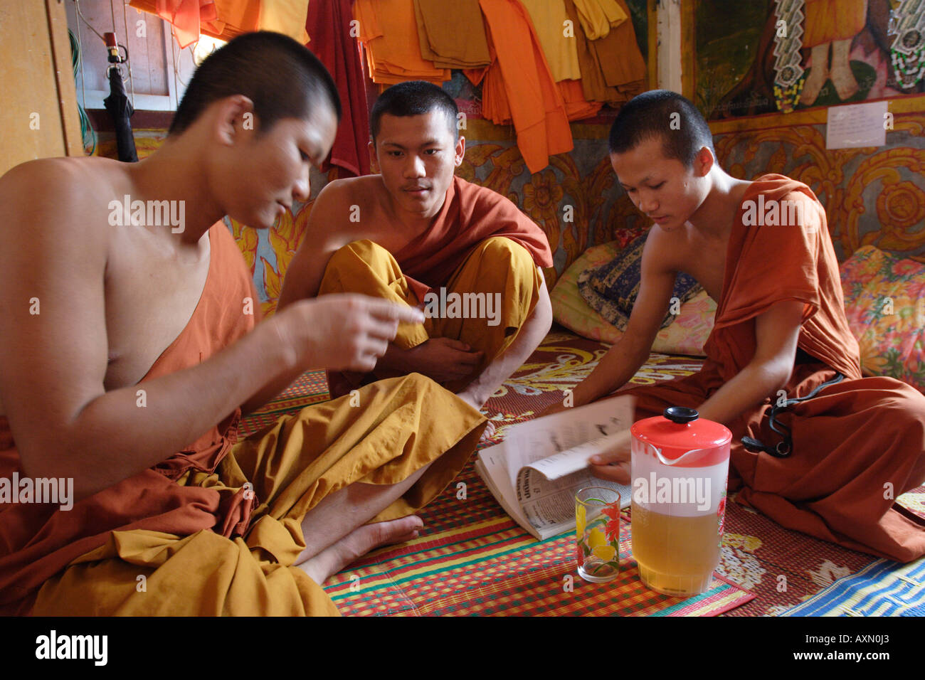 Young monks relax at their temple in Pakse, Laos Stock Photo - Alamy