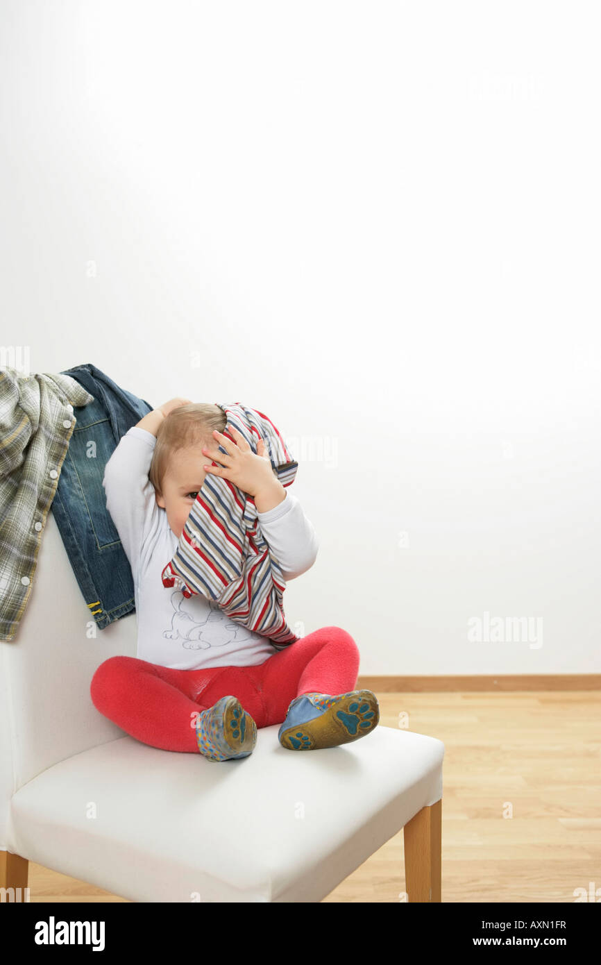 Baby boy hiding under a shirt Stock Photo - Alamy