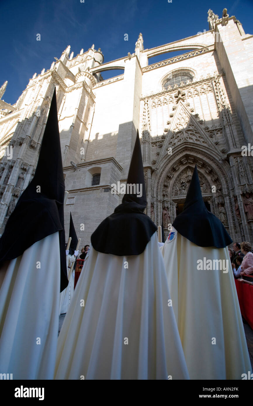 Hooded penitents entering Seville's cathedral on Holy Monday, Spain ...