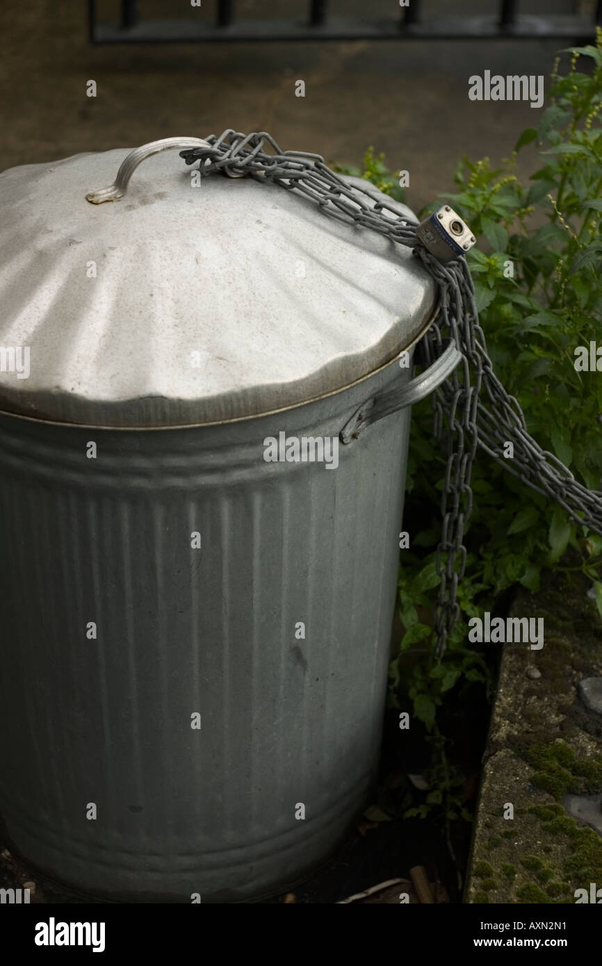 a lock and chain on a trash can lid Stock Photo - Alamy