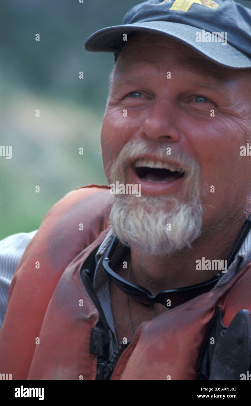 A portrait of a white male river raft guide with a white beard ...