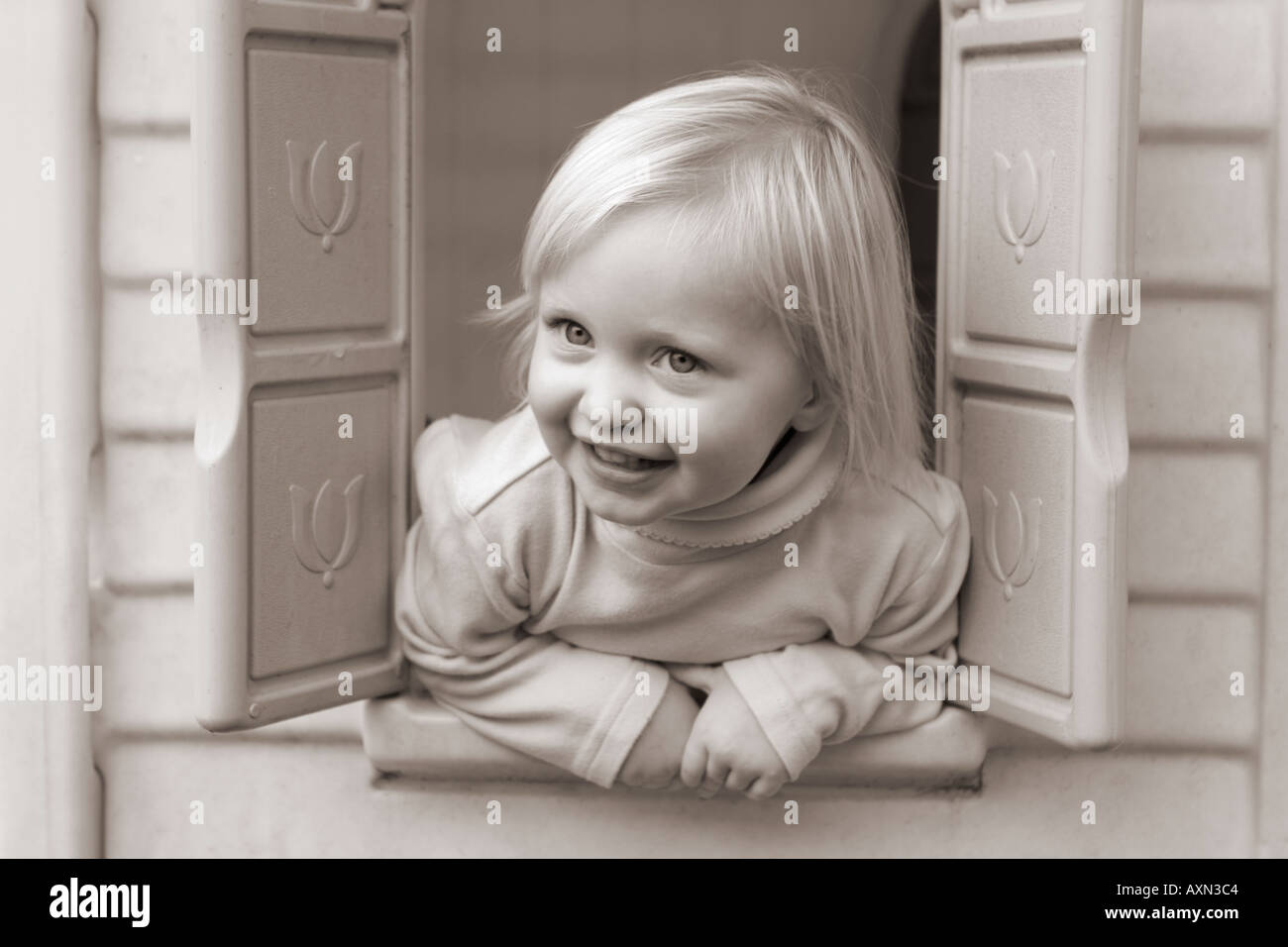 little girl leaning out of the window of her playhouse Stock Photo - Alamy