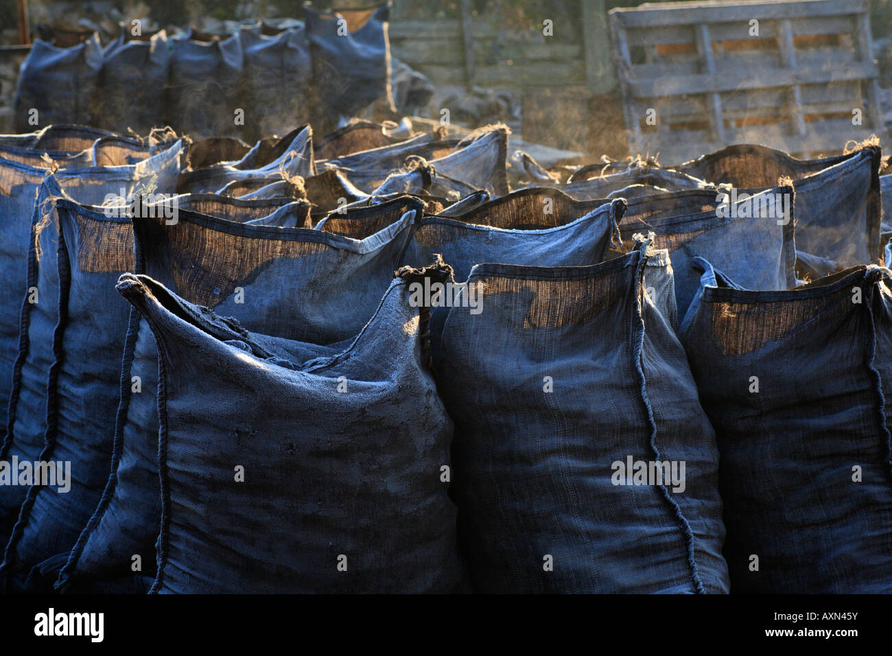 Sacks of coal on a frosty winter's morning, steam rising in the ...