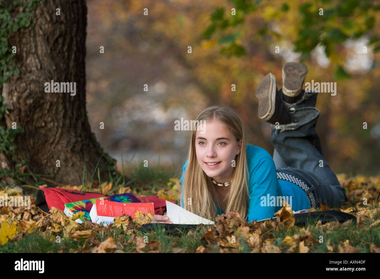 teen girl studying underneath a tree Stock Photo - Alamy