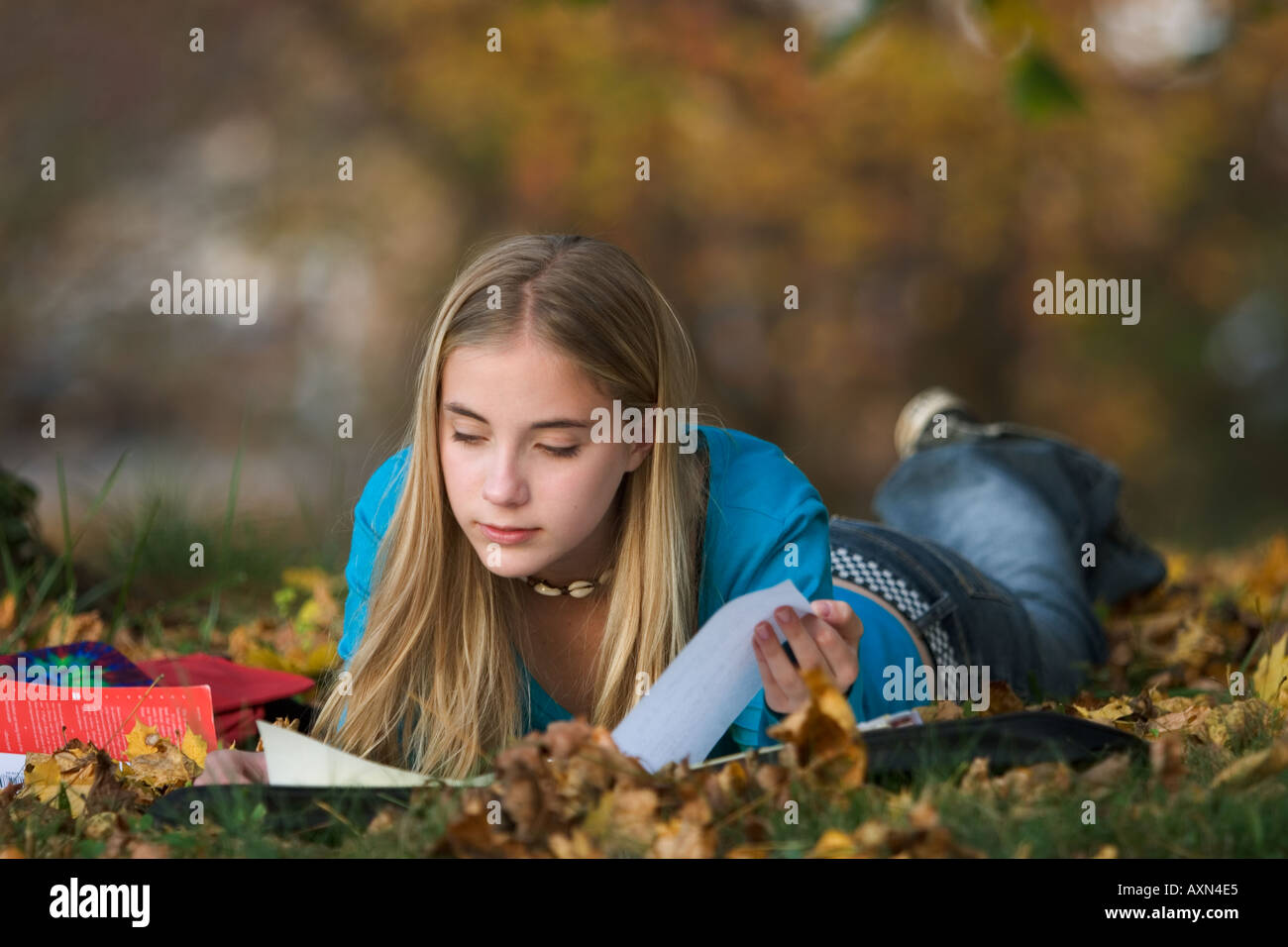 teen girl studying underneath a tree Stock Photo - Alamy
