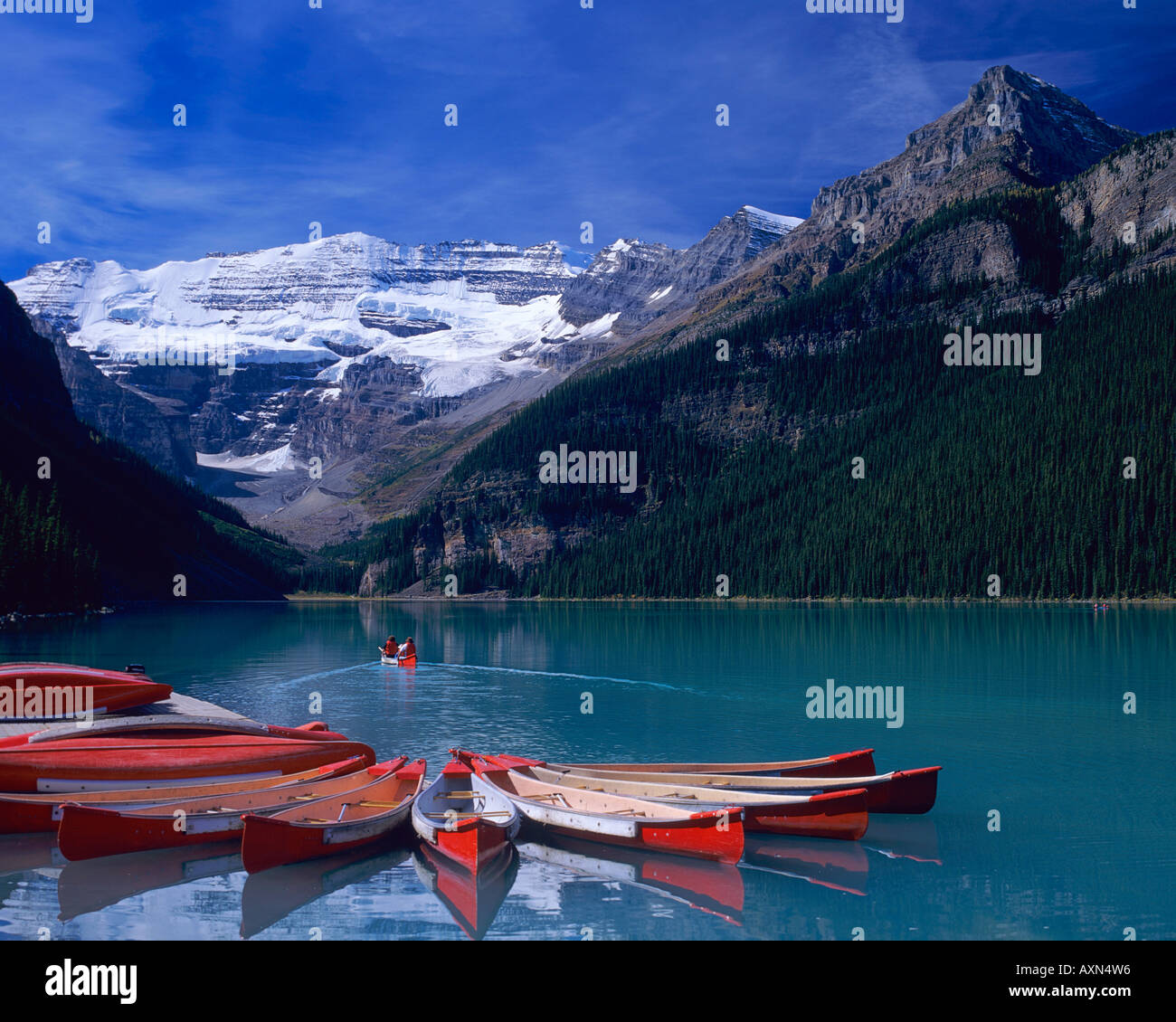 Red canoes on Lake Louise with Mount Victoria and Victoria Glacier ...