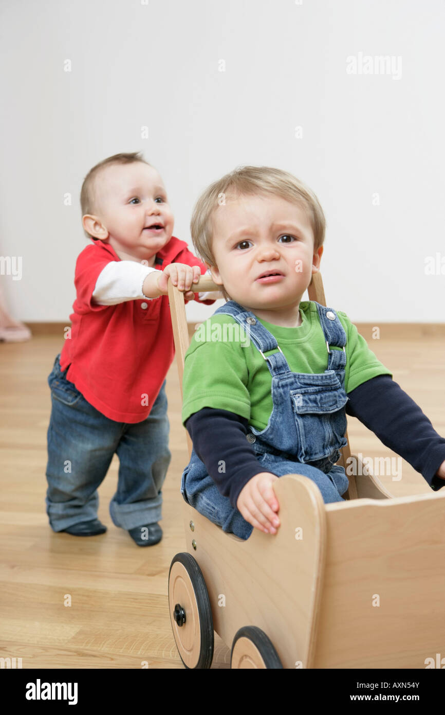 Two baby boys playing together Stock Photo - Alamy