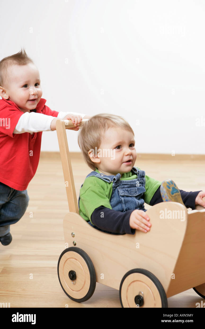 Two baby boys playing together Stock Photo - Alamy