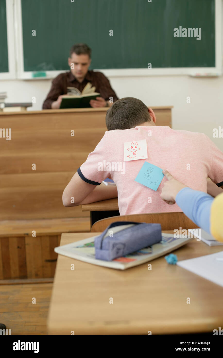 Slips of paper on teenage boy's back Stock Photo - Alamy