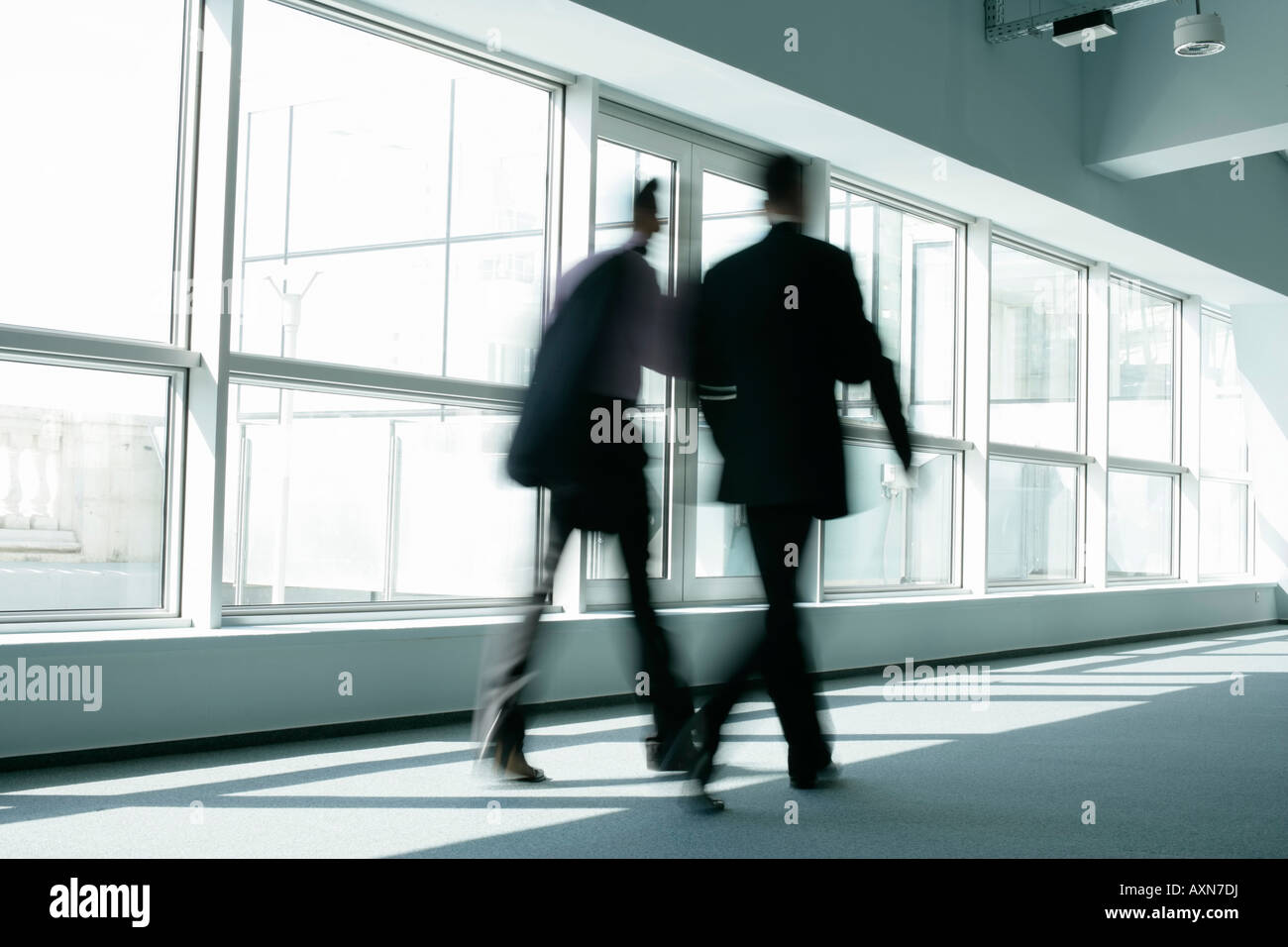 Two businessmen passing Stock Photo - Alamy
