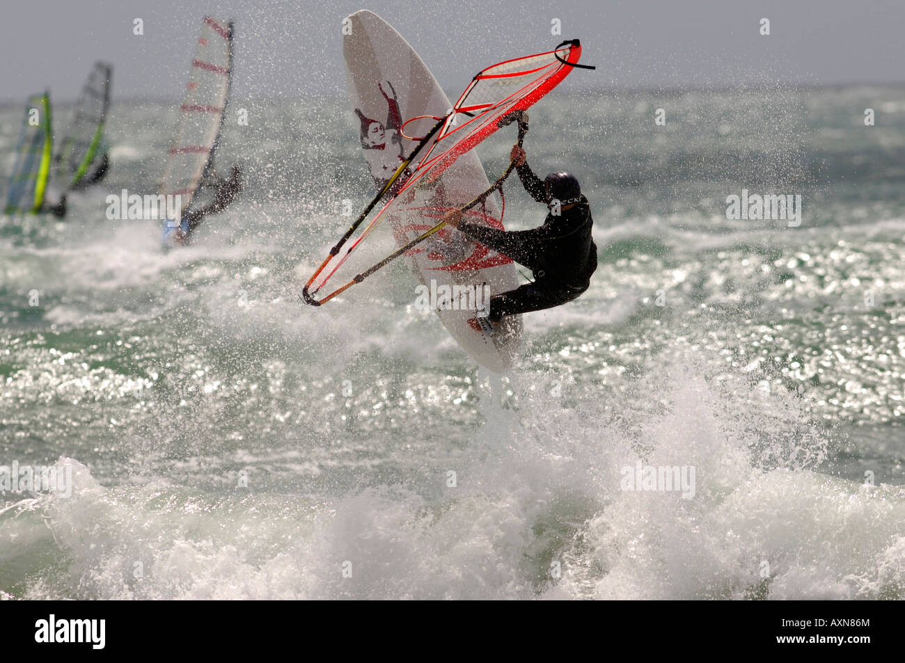 Windsurfer launching off wave Stock Photo - Alamy