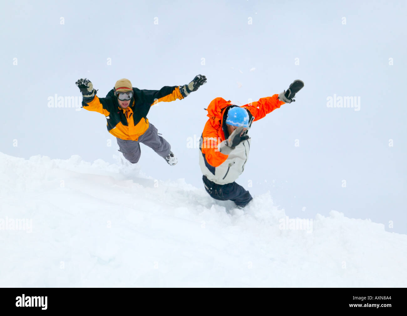 young friends diving headfirst into snow Stock Photo - Alamy