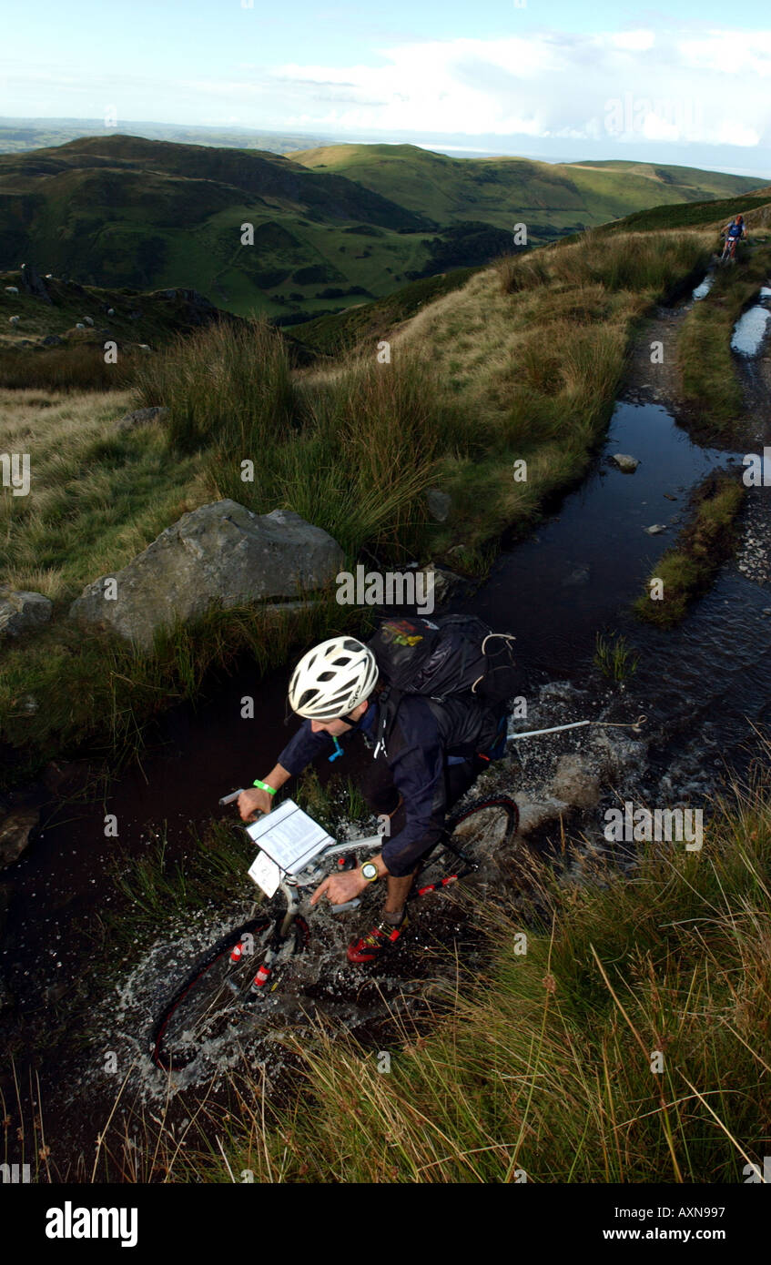 Mountain bike rider splashing through water on trail Stock Photo - Alamy