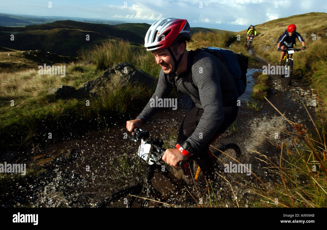 Mountain bike rider splashing through water on trail Stock Photo - Alamy