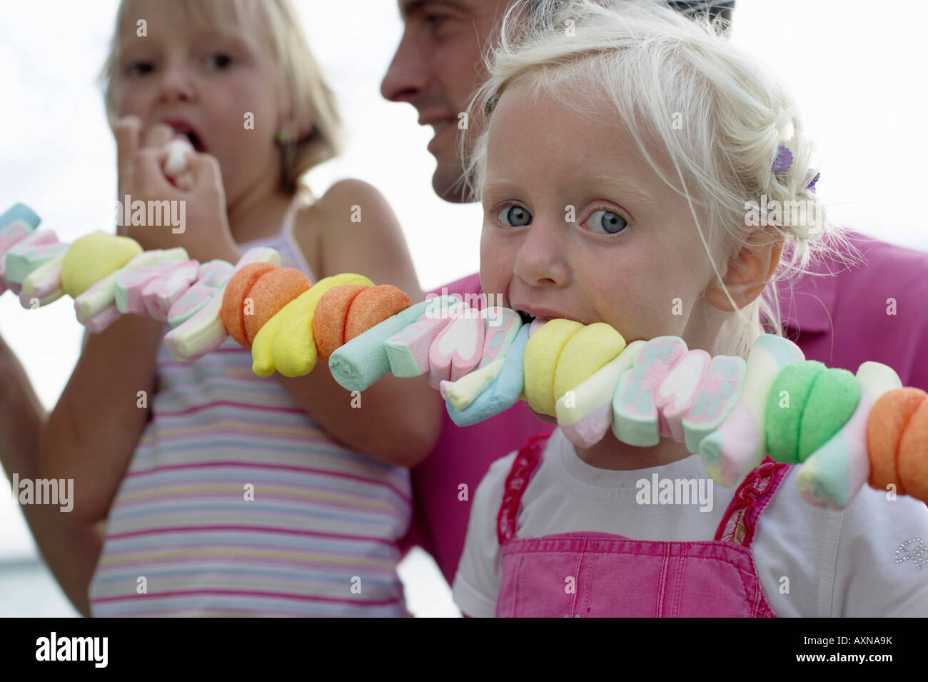 Children with a huge spit of sweets, close-up Stock Photo - Alamy
