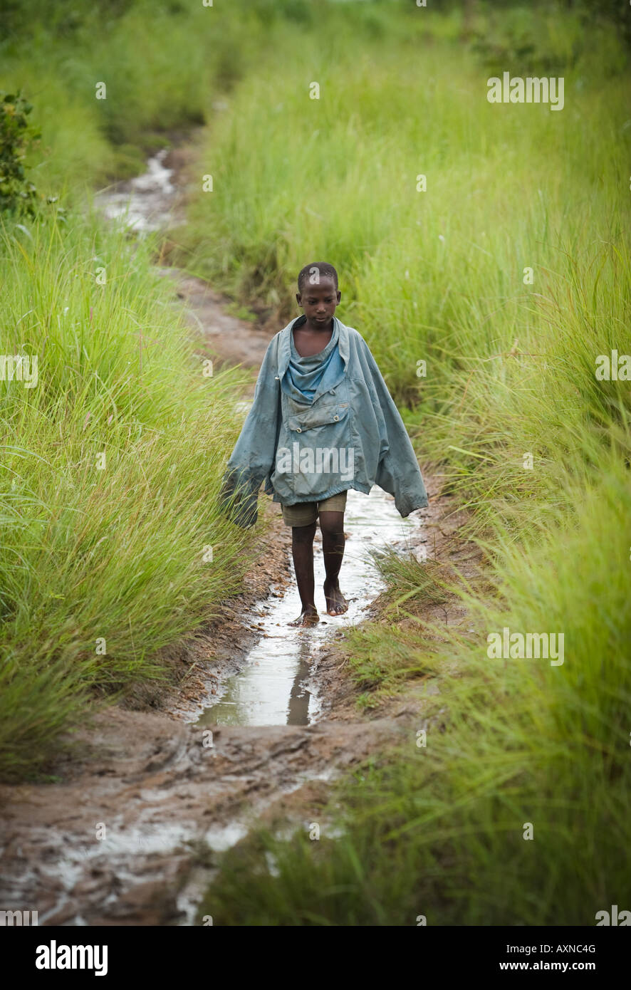 A boy walks on a muddy footpath Stock Photo - Alamy