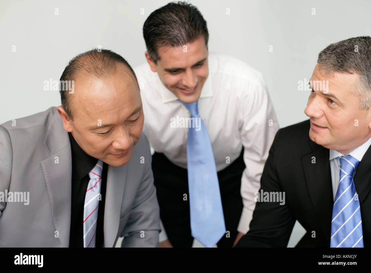Three businessmen having a meeting Stock Photo - Alamy