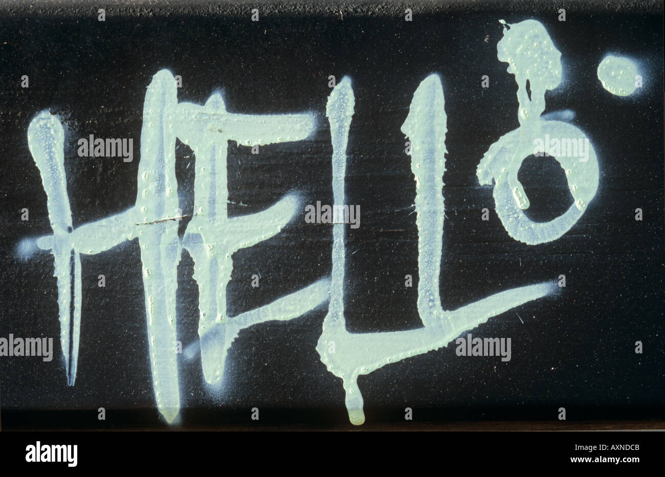 Graffiti on black wall or door or bench saying Hello Stock Photo - Alamy