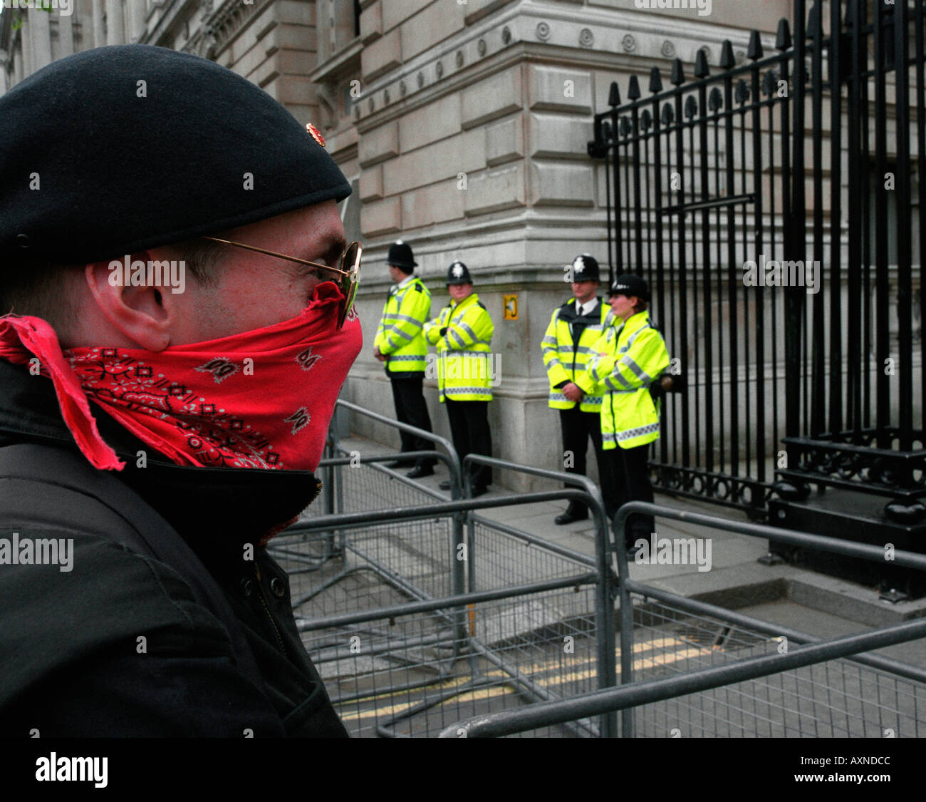 Masked demonstrator at the security gates of Downing Street London ...