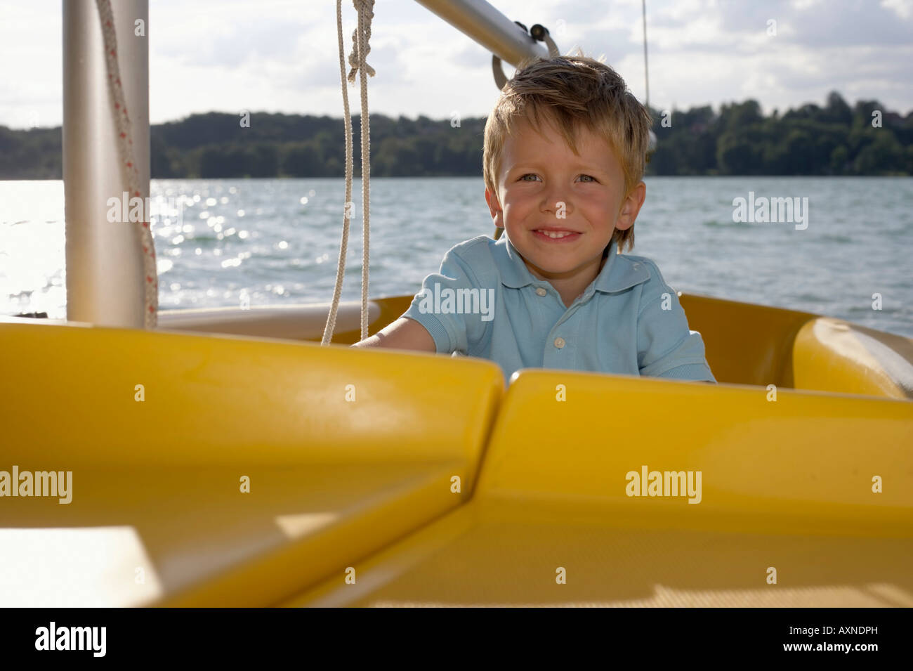 Little boy driving a plastic boat Stock Photo - Alamy