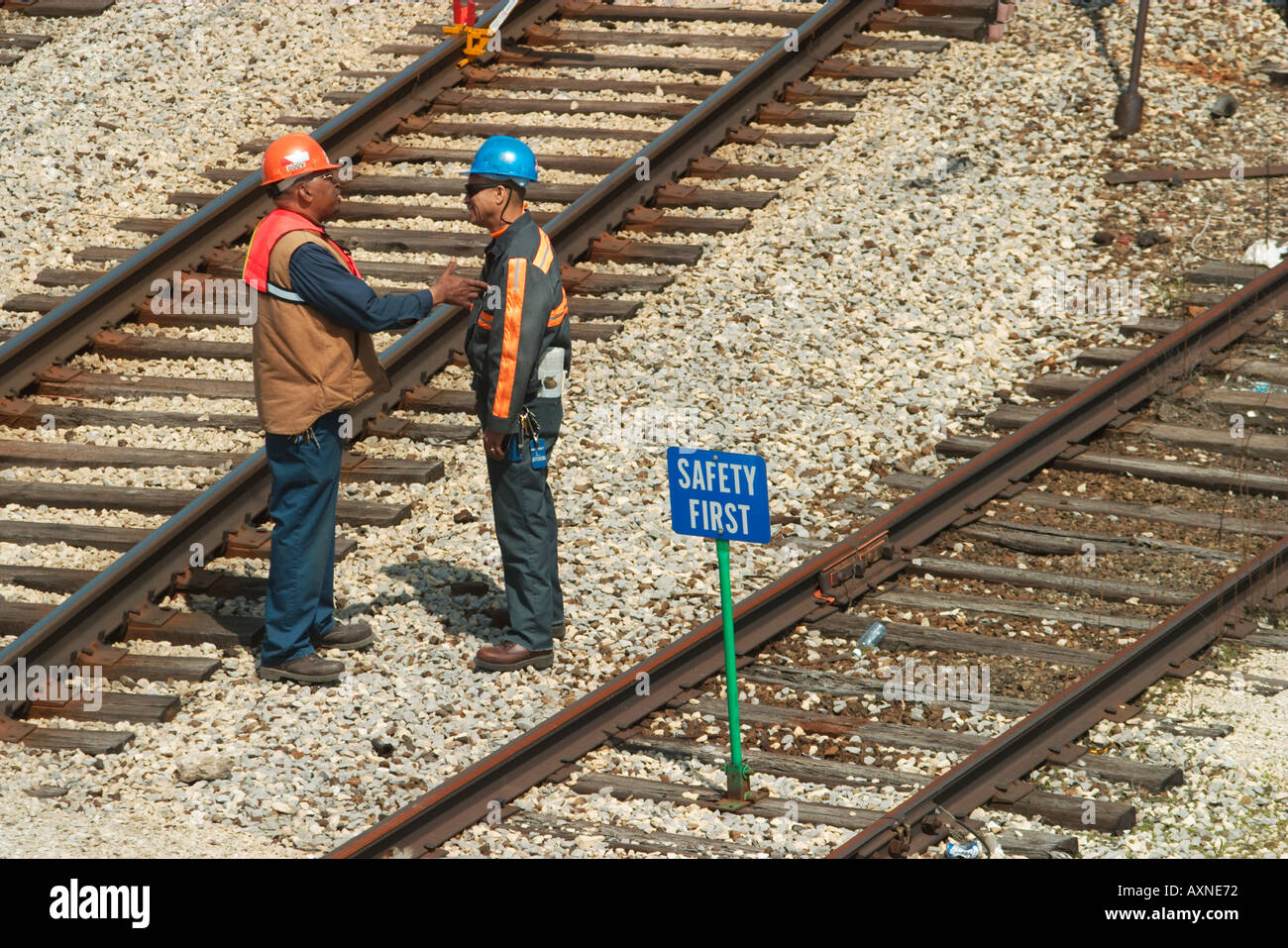 ILLINOIS Chicago Two men wear safety helmets talk alongside railroad ...