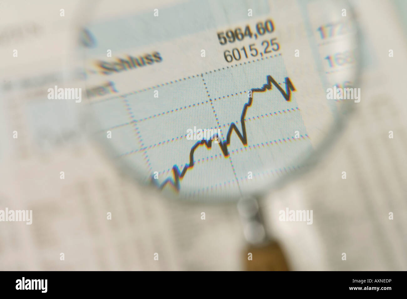 Lens held over a finance paper, selective focus Stock Photo - Alamy