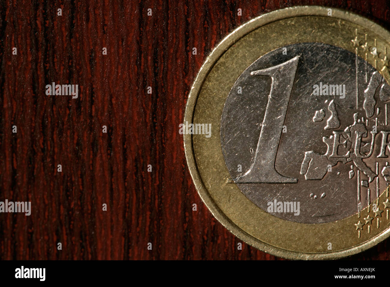 Single Euro coin on wooden underlay (part of), close-up Stock Photo - Alamy