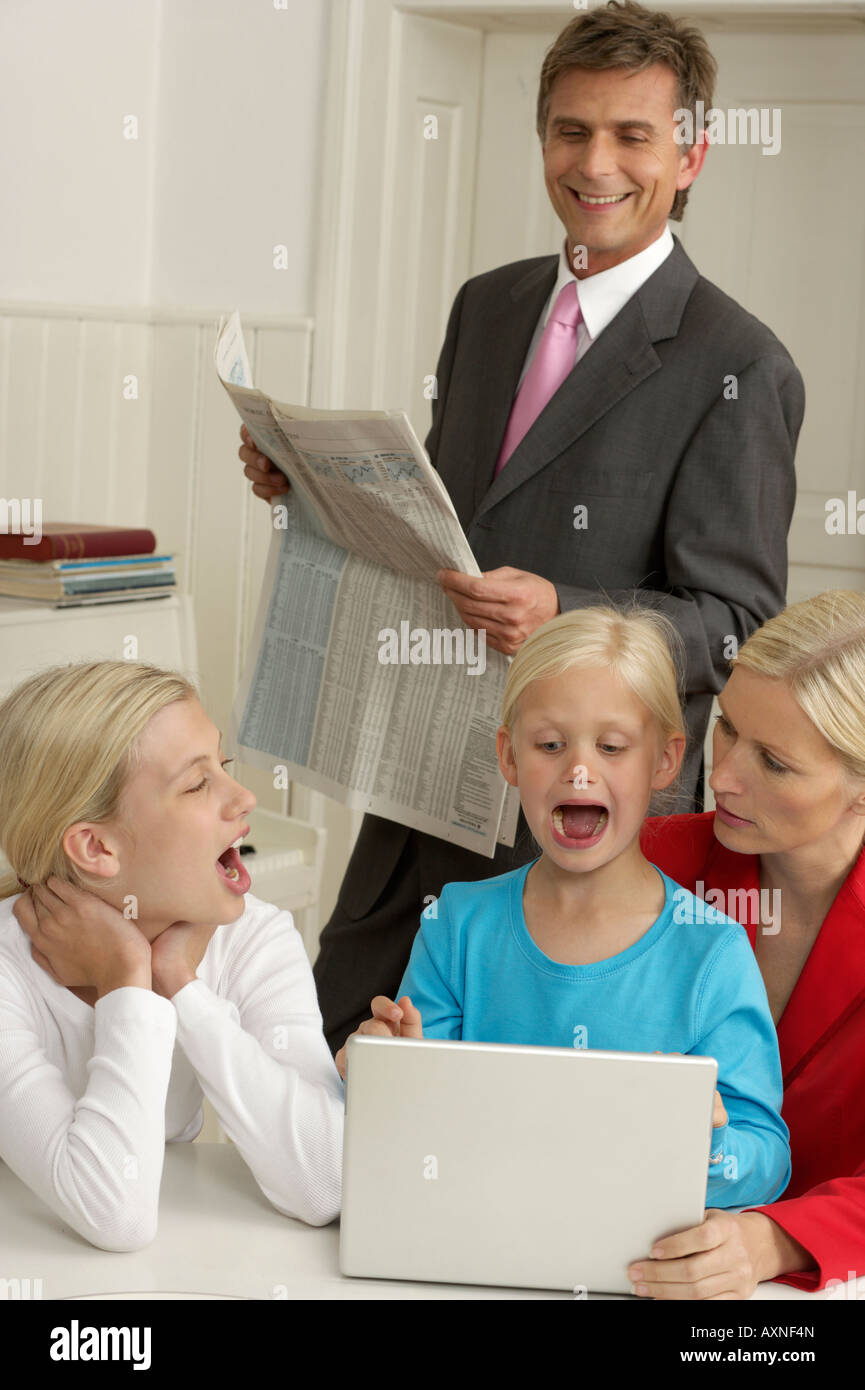 Father with financial paper looking at his two daughters who are ...