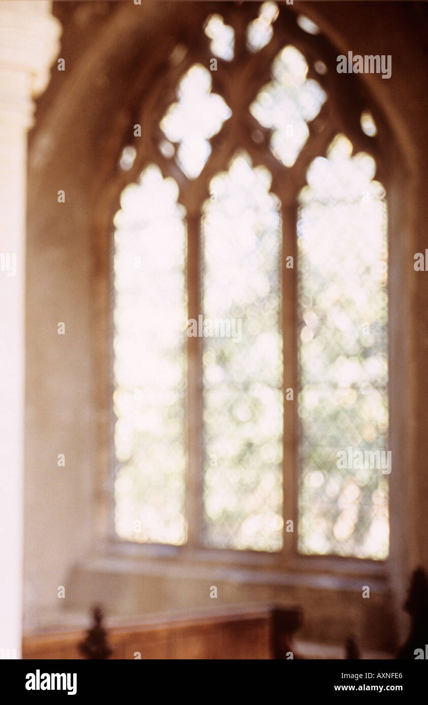 Clear leaded church or chapel window with summer foliage visible ...