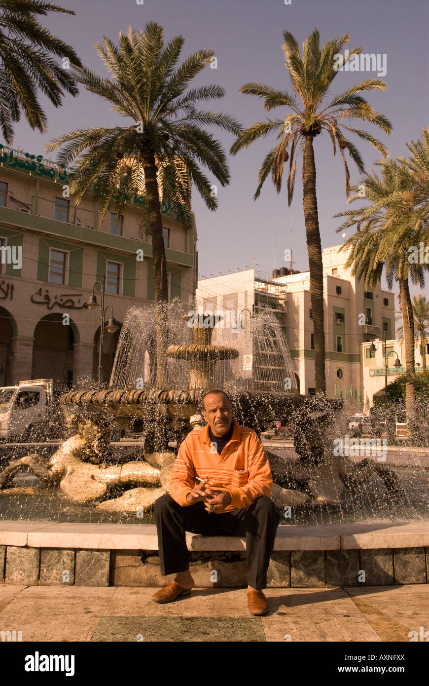 Libyan man relaxing by Italian fountain Green Square Tripoli Libya ...