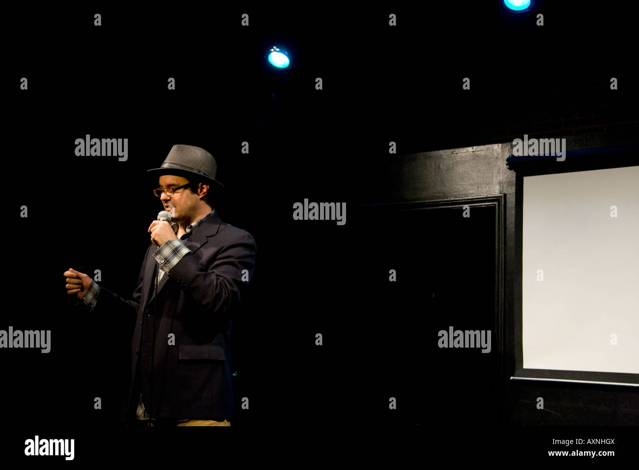 comedian onstage telling jokes Stock Photo - Alamy