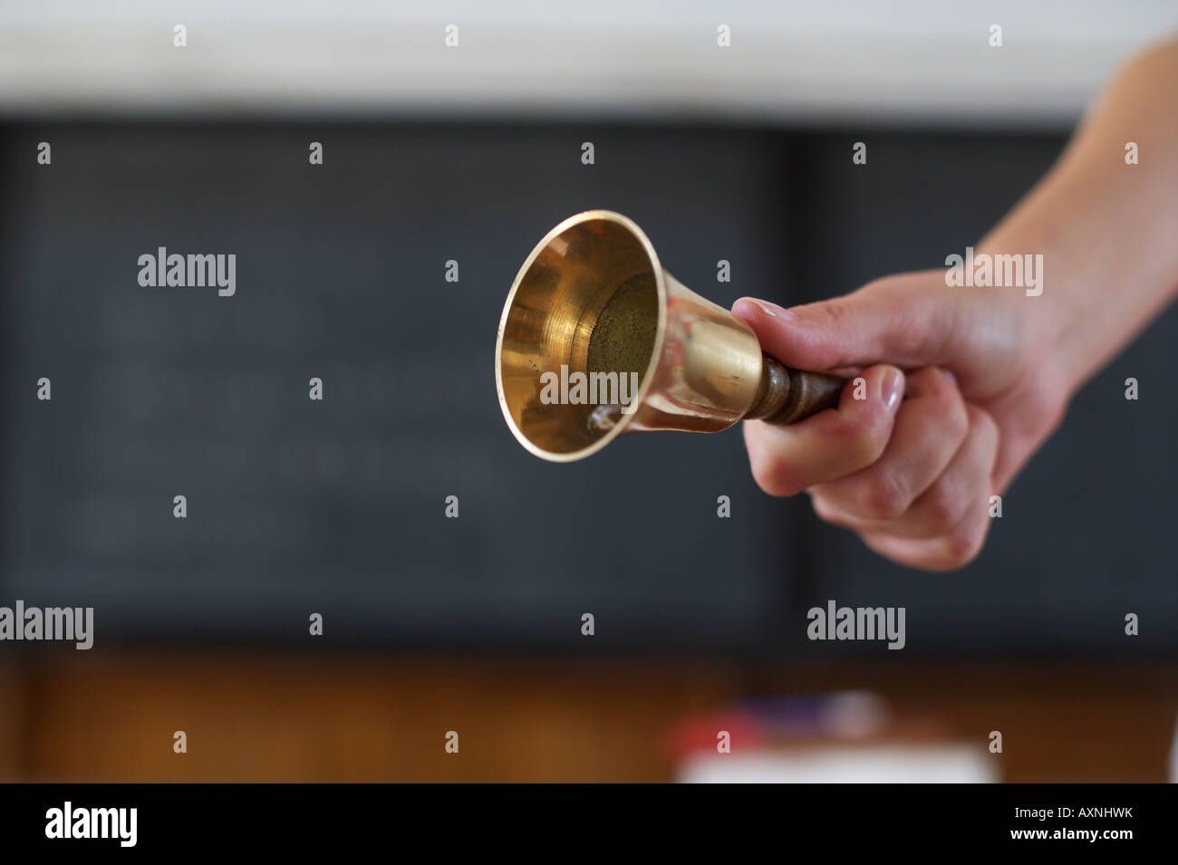 Hand holding a bell, up-up, selective focus Stock Photo - Alamy