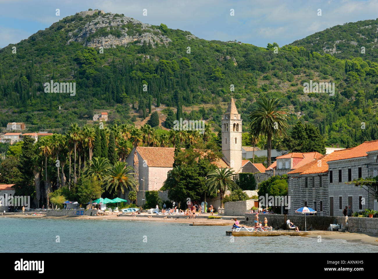 The church and narrow beach on the Elaphite island of Lopud in Croatia ...