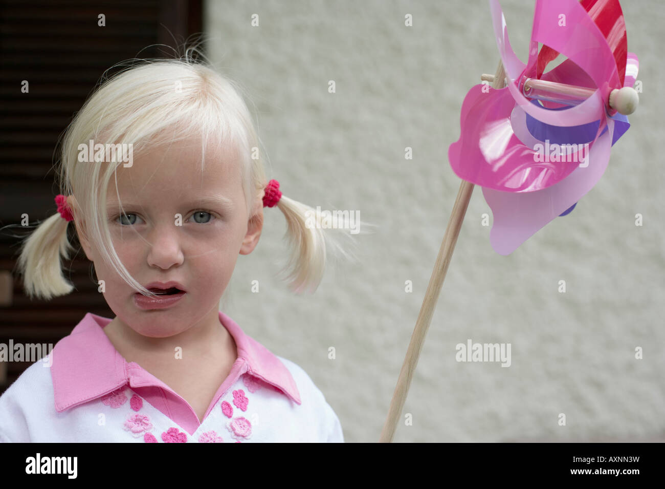 Little girl with a pin wheel in her hand Stock Photo - Alamy