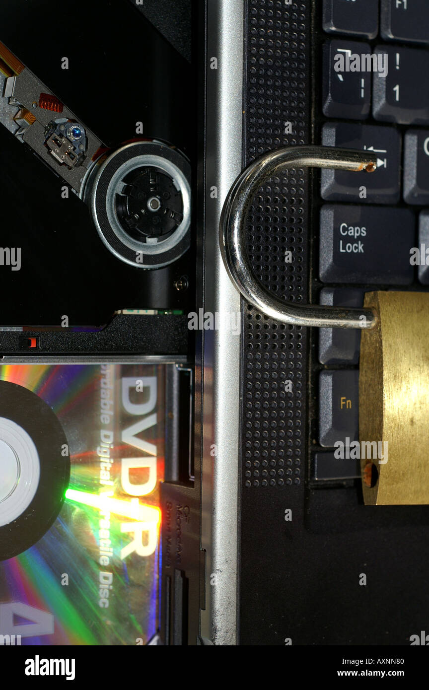 Laptop keyboard optical reader with padlock and DVD disc Stock Photo ...