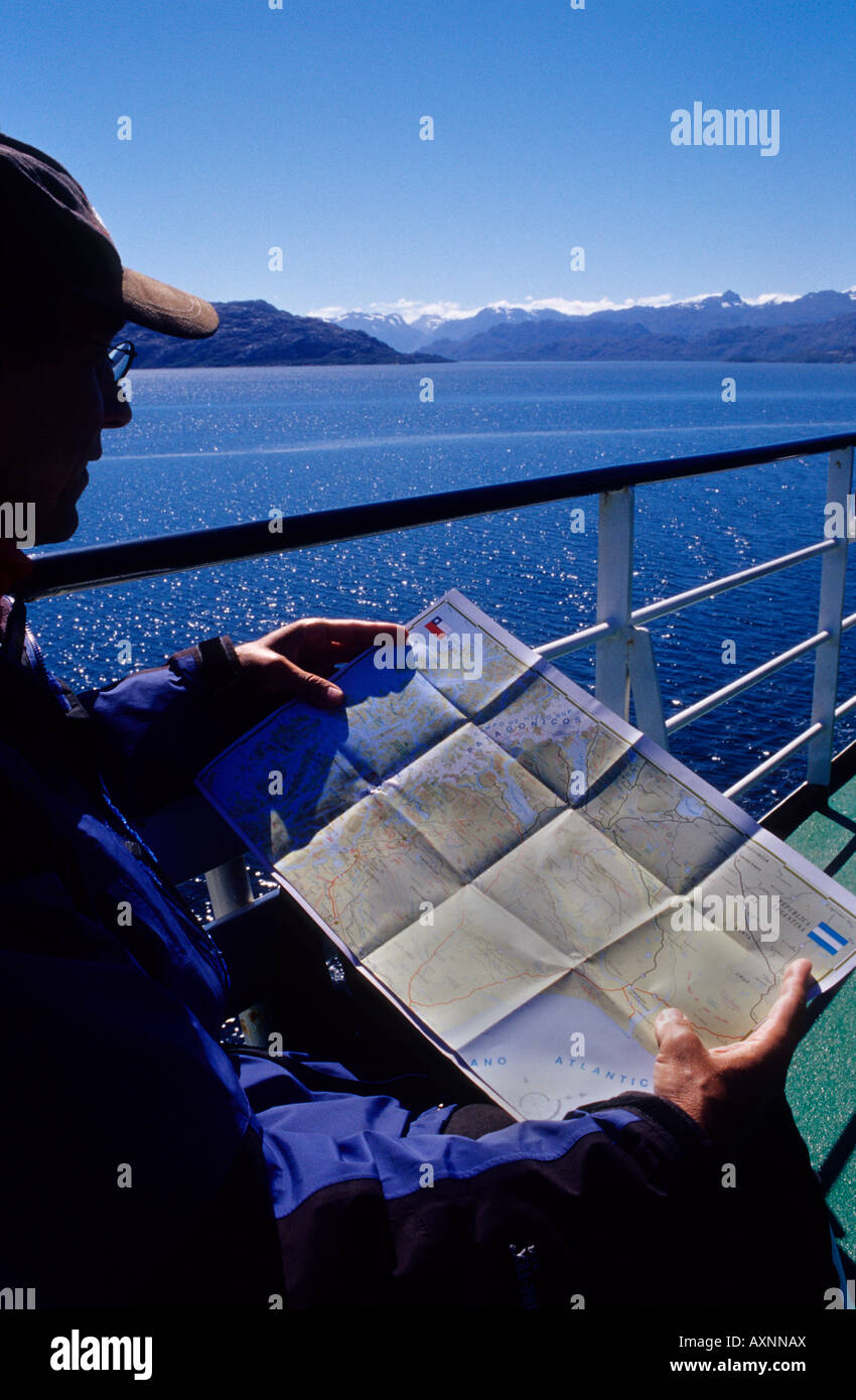 Tourist watching a Patagonian Channels Map on the ferry from Puerto ...