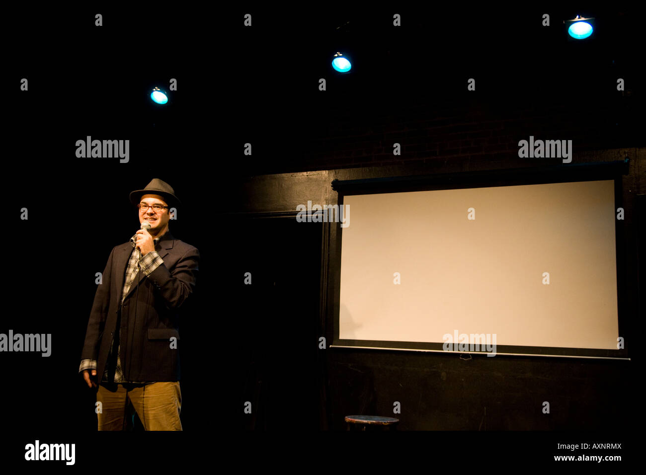 comedian onstage telling jokes Stock Photo - Alamy