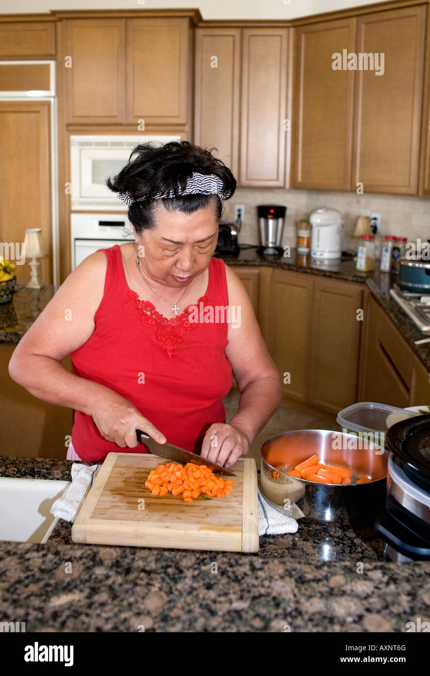 Female Chinese Cook preparing vegetables Stock Photo - Alamy