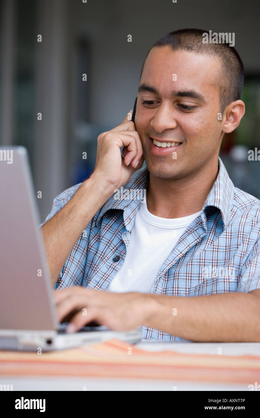 Young man talking on telephone Stock Photo - Alamy