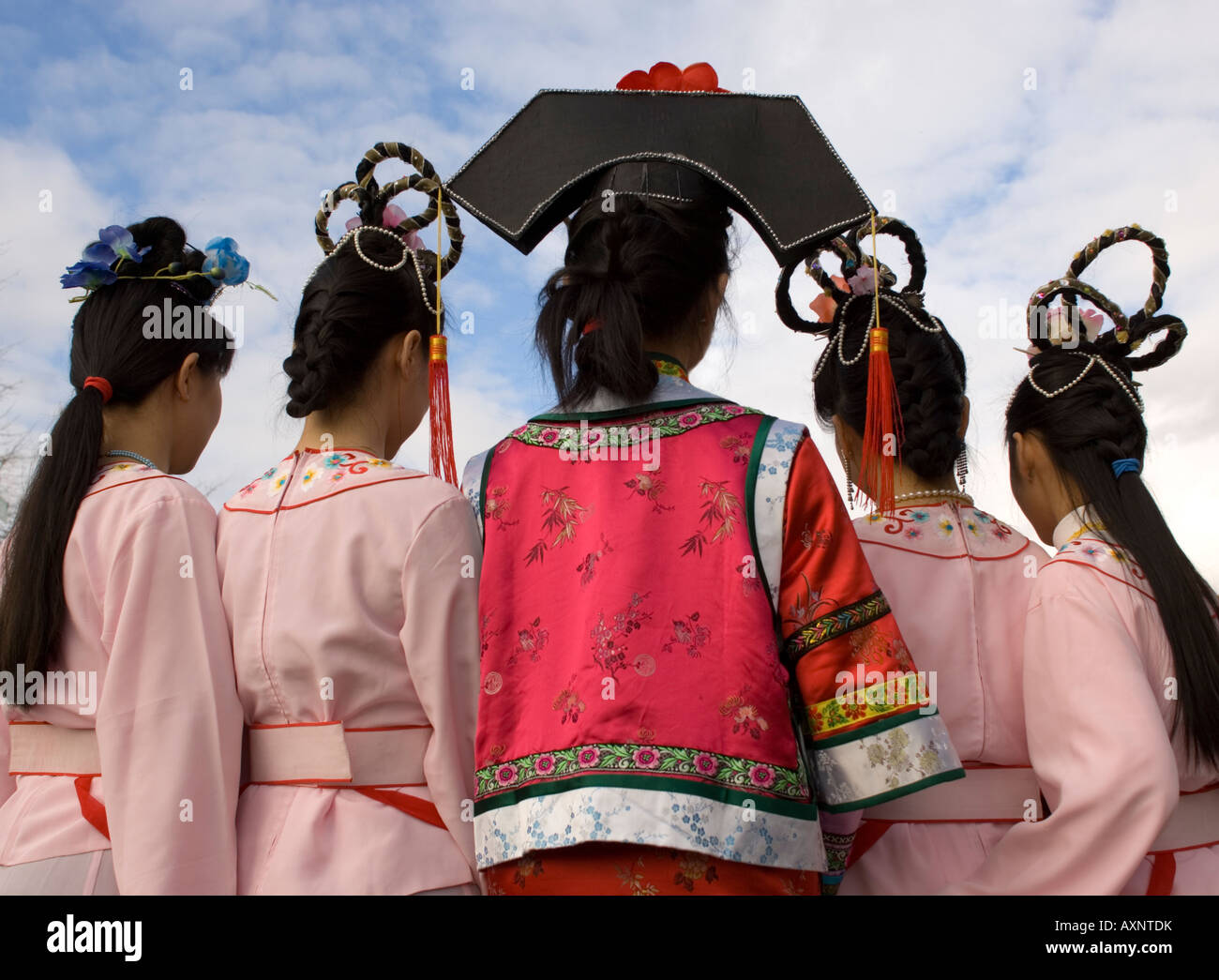 five Chinese dancers viewed from the back as they pose for a photograph ...
