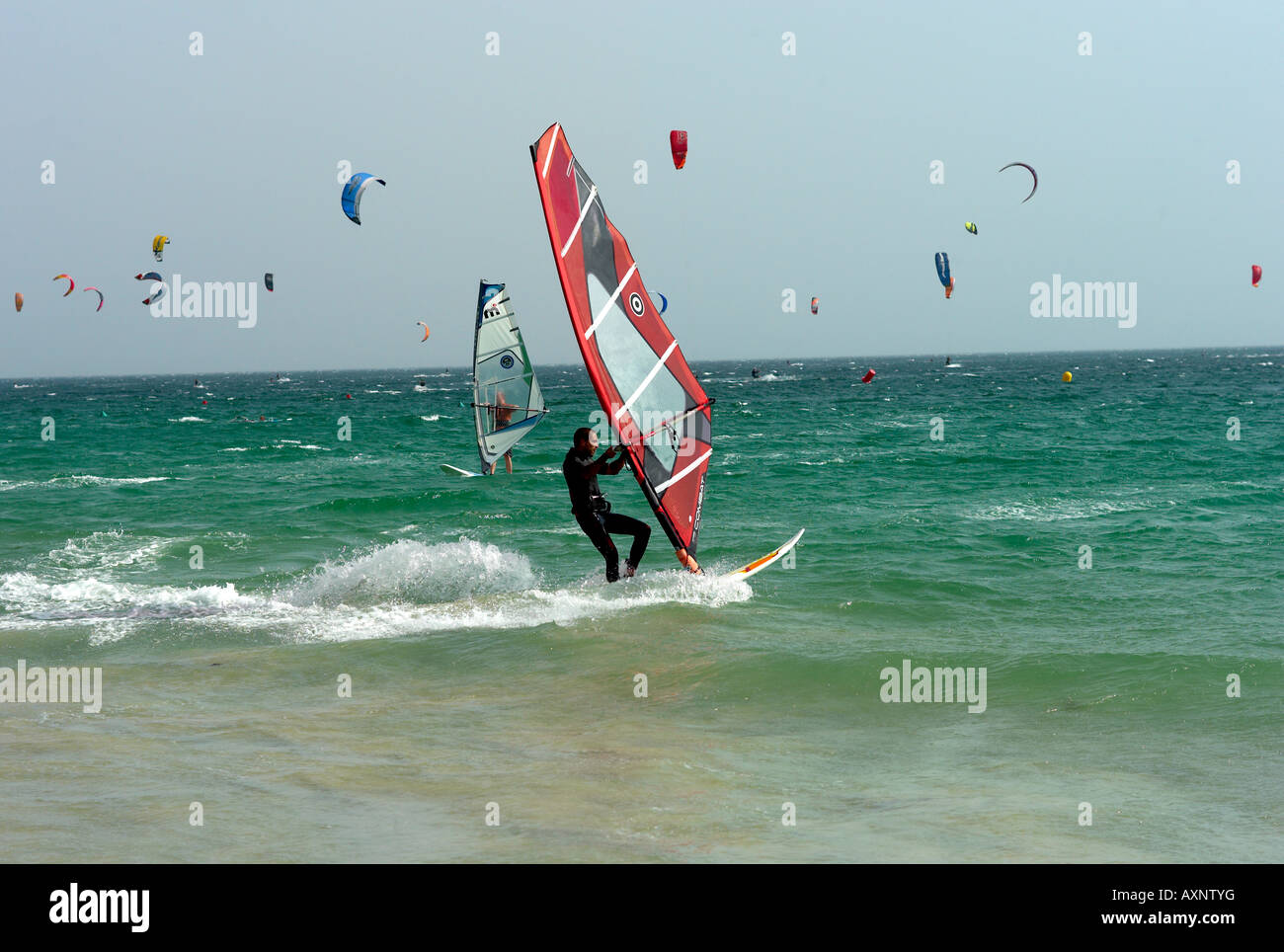 A windsurfer sails by as seen from the beach in Tarifa in the south of ...