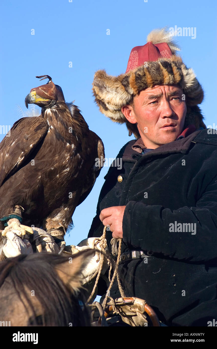 An eagle hunter prepares to demonstrate his eagle for spectators at the ...