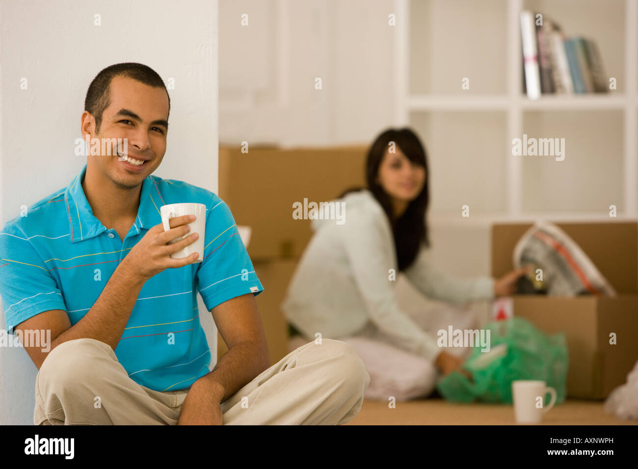 Young Couple Unpacking Moving Boxes Stock Photo Alamy