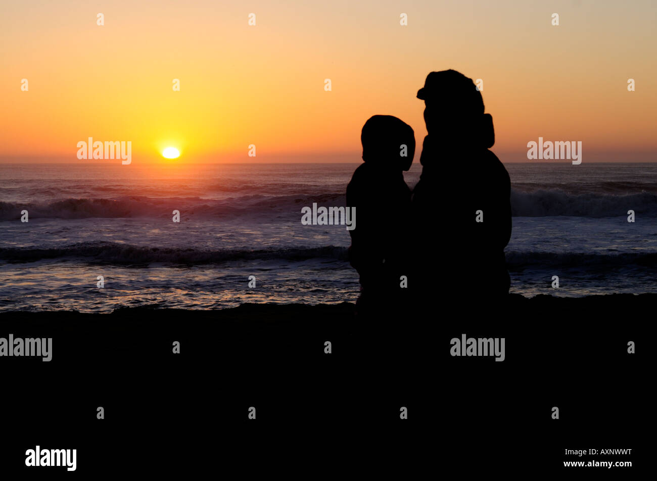 Child watching the waves at sunset hi-res stock photography and images ...