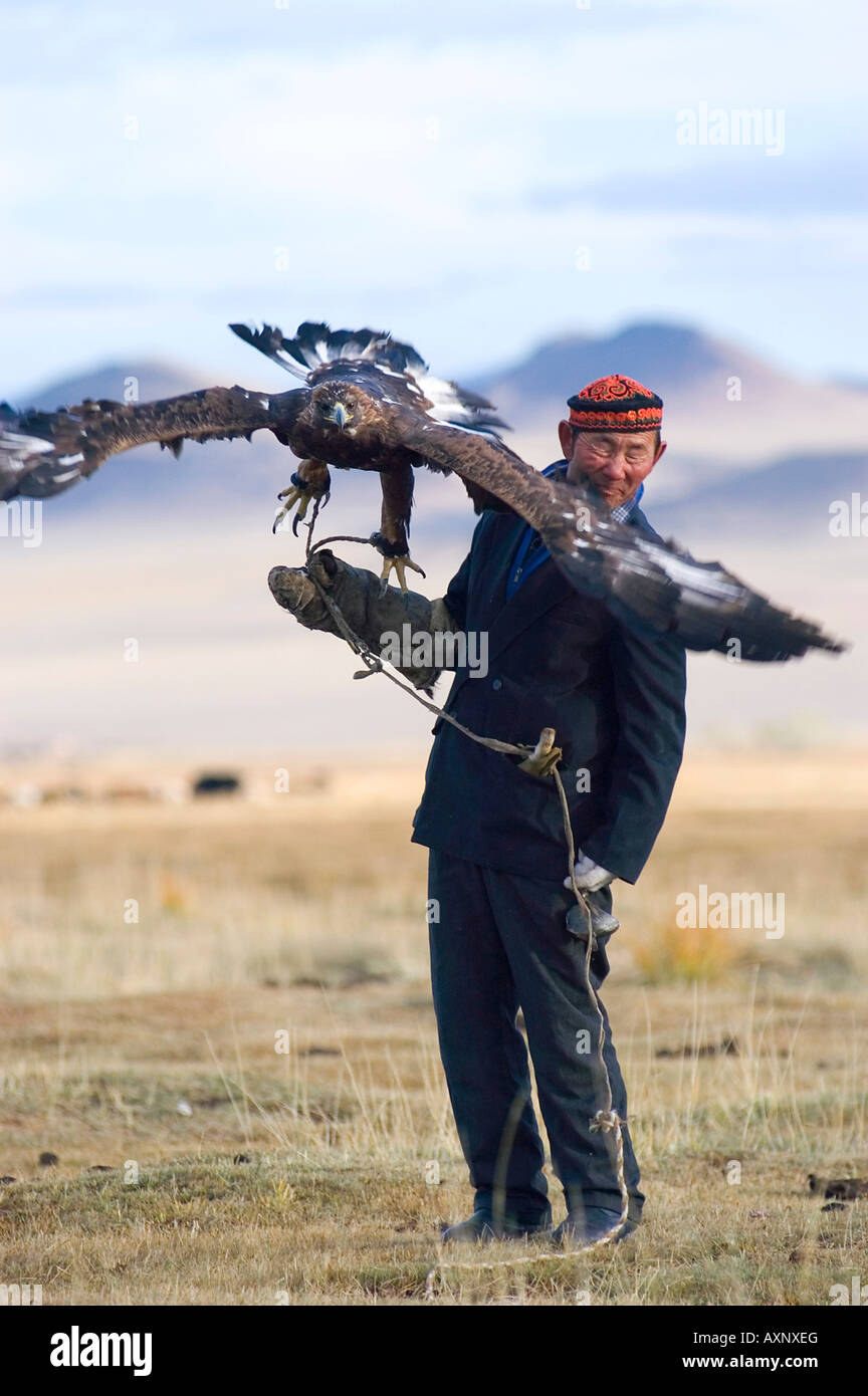 An eagle hunter prepares to demonstrate his eagle for spectators at the ...