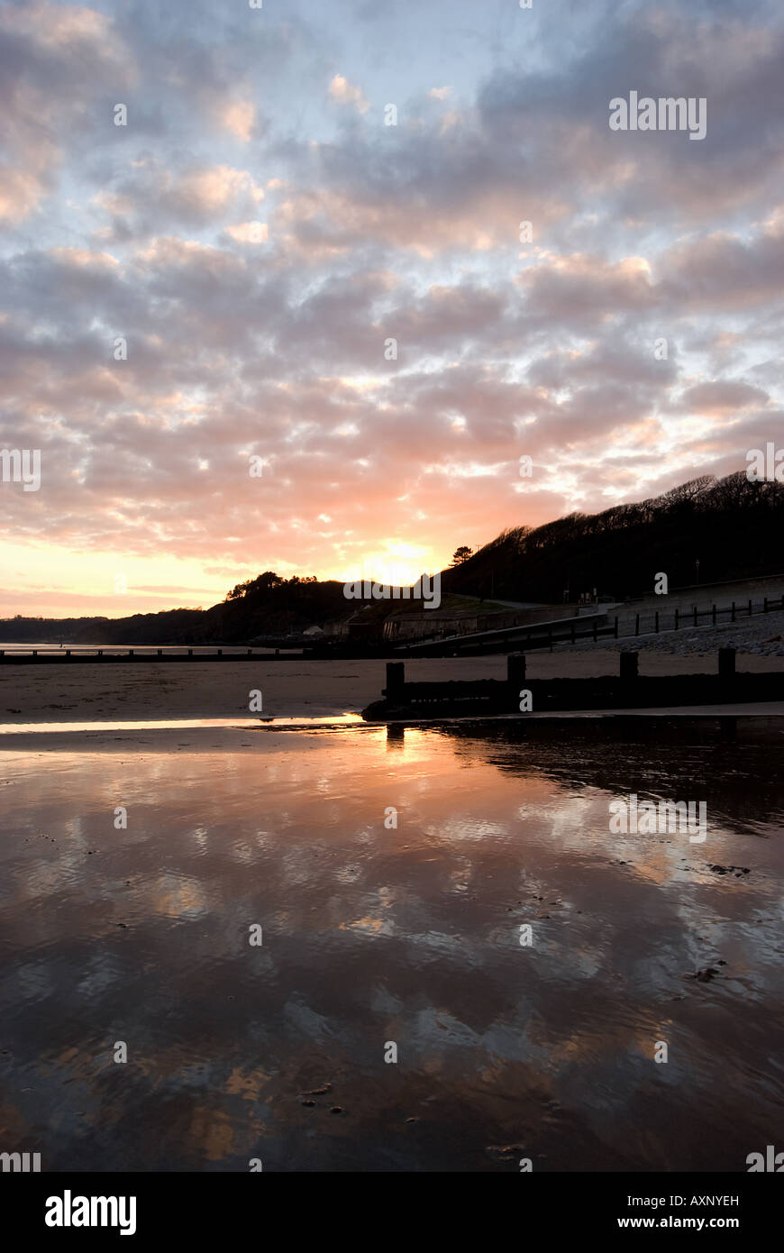 Sunset reflections on beach Stock Photo - Alamy