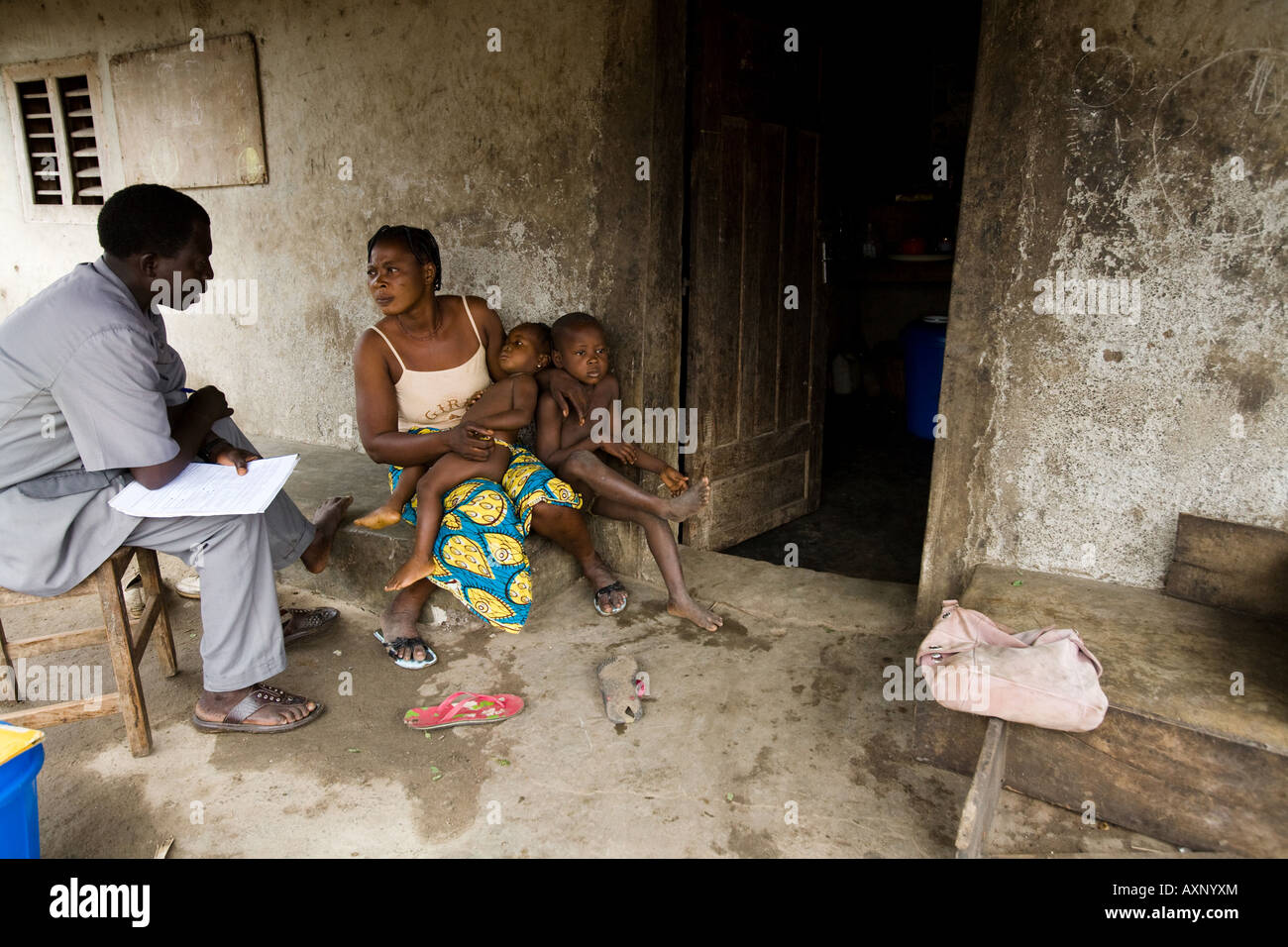 Health worker interviewing mother and children, Benin, Africa Stock ...